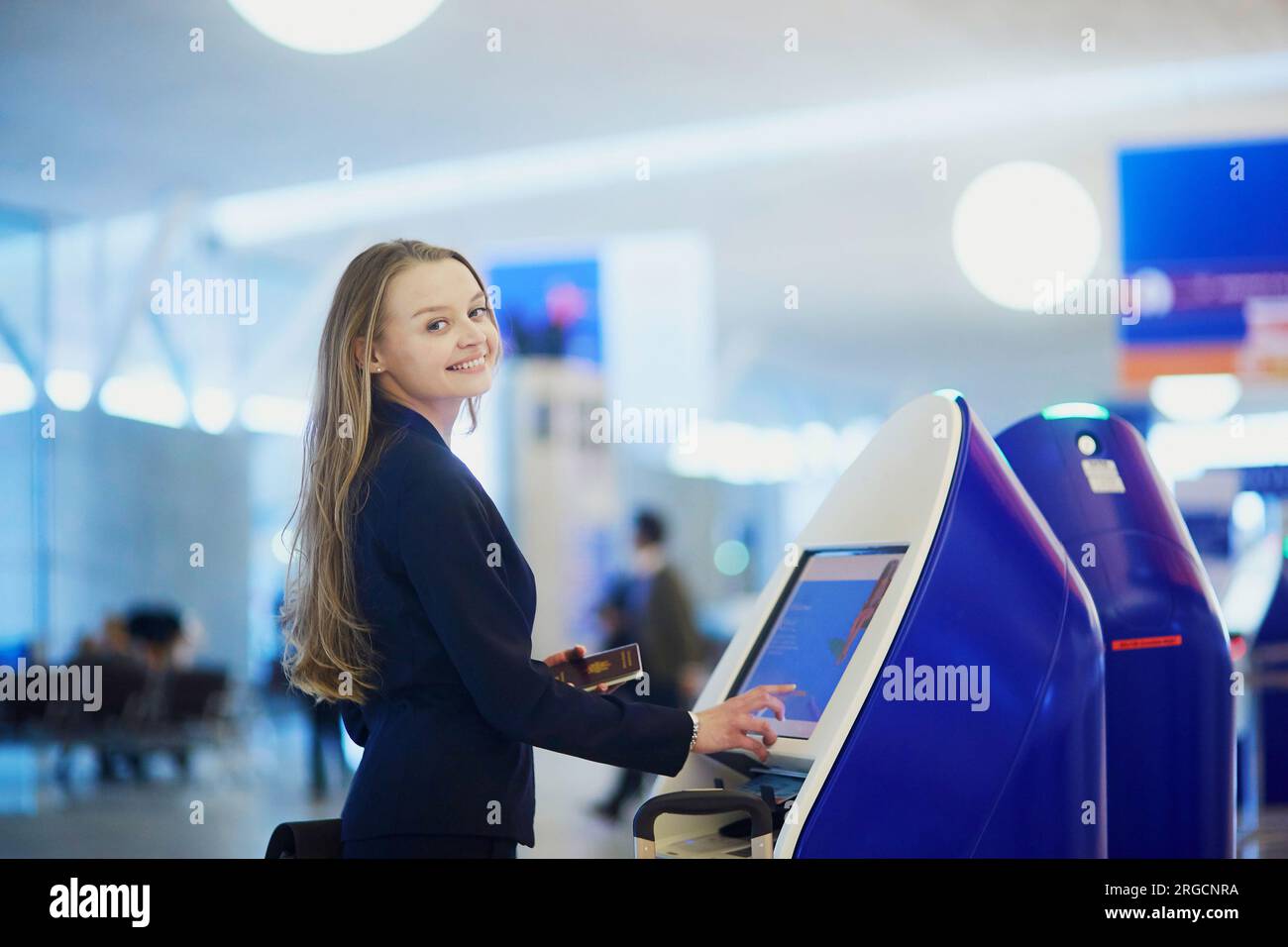 Young elegant business woman holding passport and boarding pass, doing ...