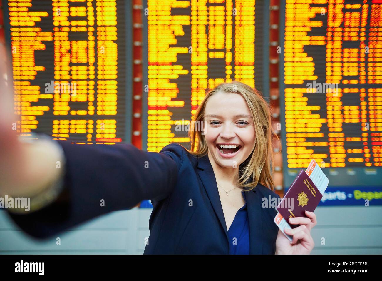 Happy young woman, holding French passport and boarding pass, doing ...