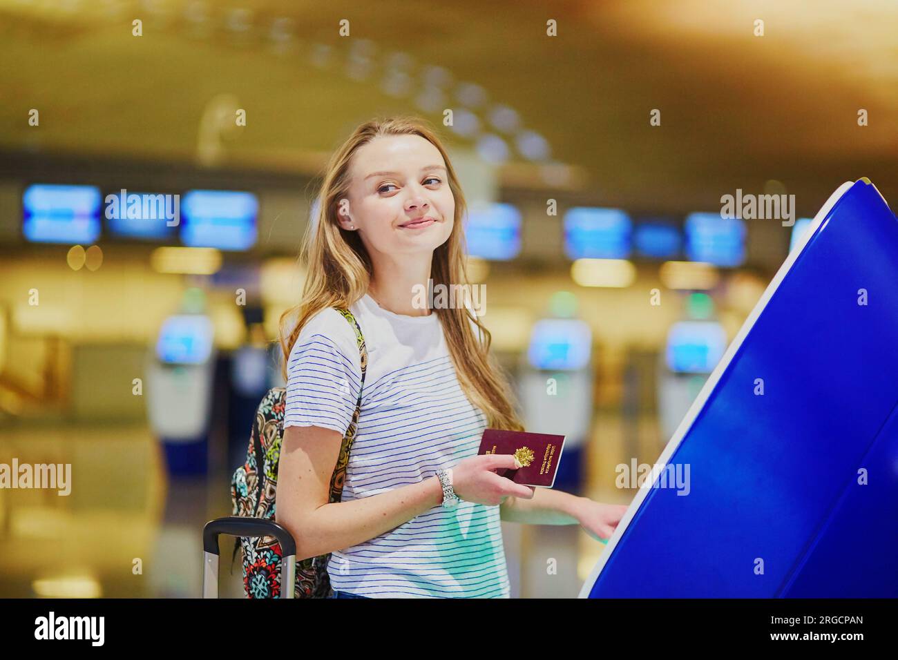 Beautiful young tourist girl with backpack and carry on luggage in ...