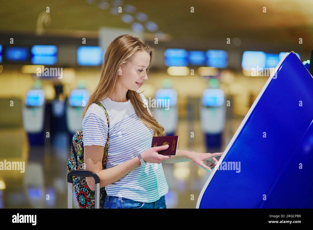 Beautiful young tourist girl with backpack and carry on luggage in ...