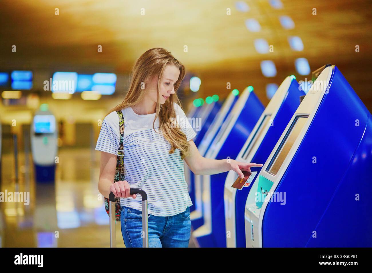Beautiful young tourist girl with backpack and carry on luggage in ...