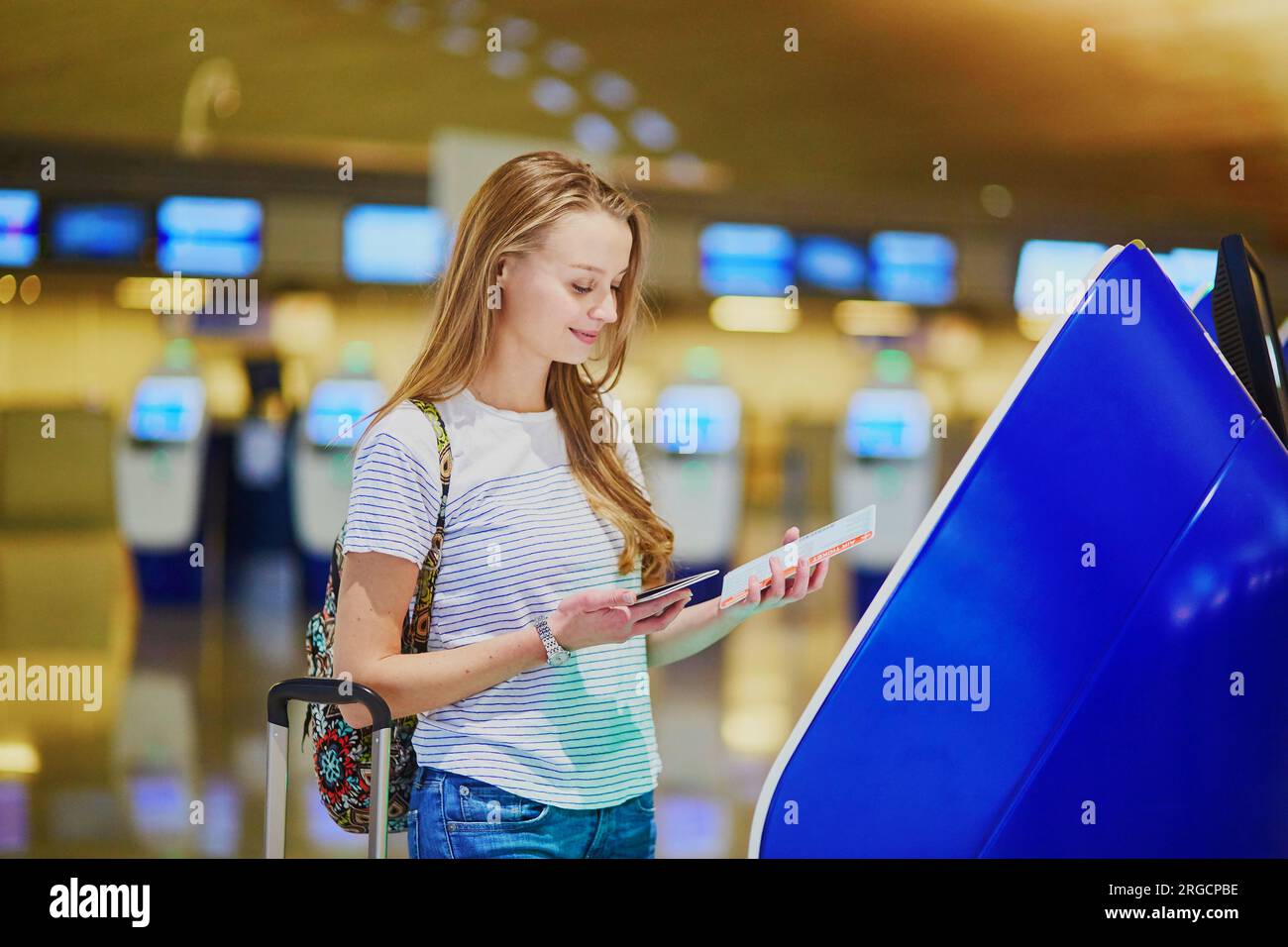Beautiful young tourist girl with backpack and carry on luggage in ...