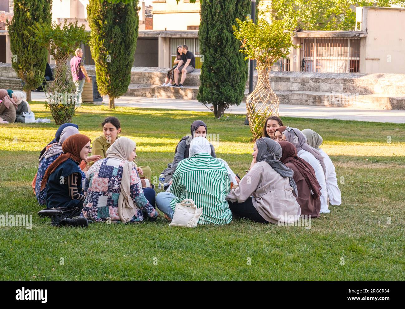 Istanbul, Turkey, Turkiye. Turkish Muslim Girls Relaxing on the Lawn of ...