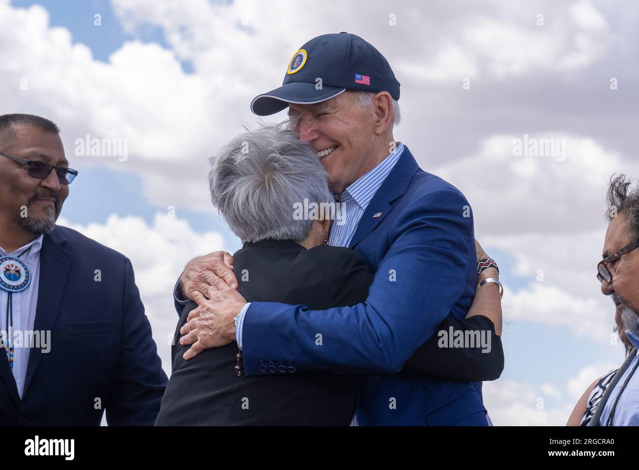 President Joe Biden hugs a supporter after signing a proclamation ...