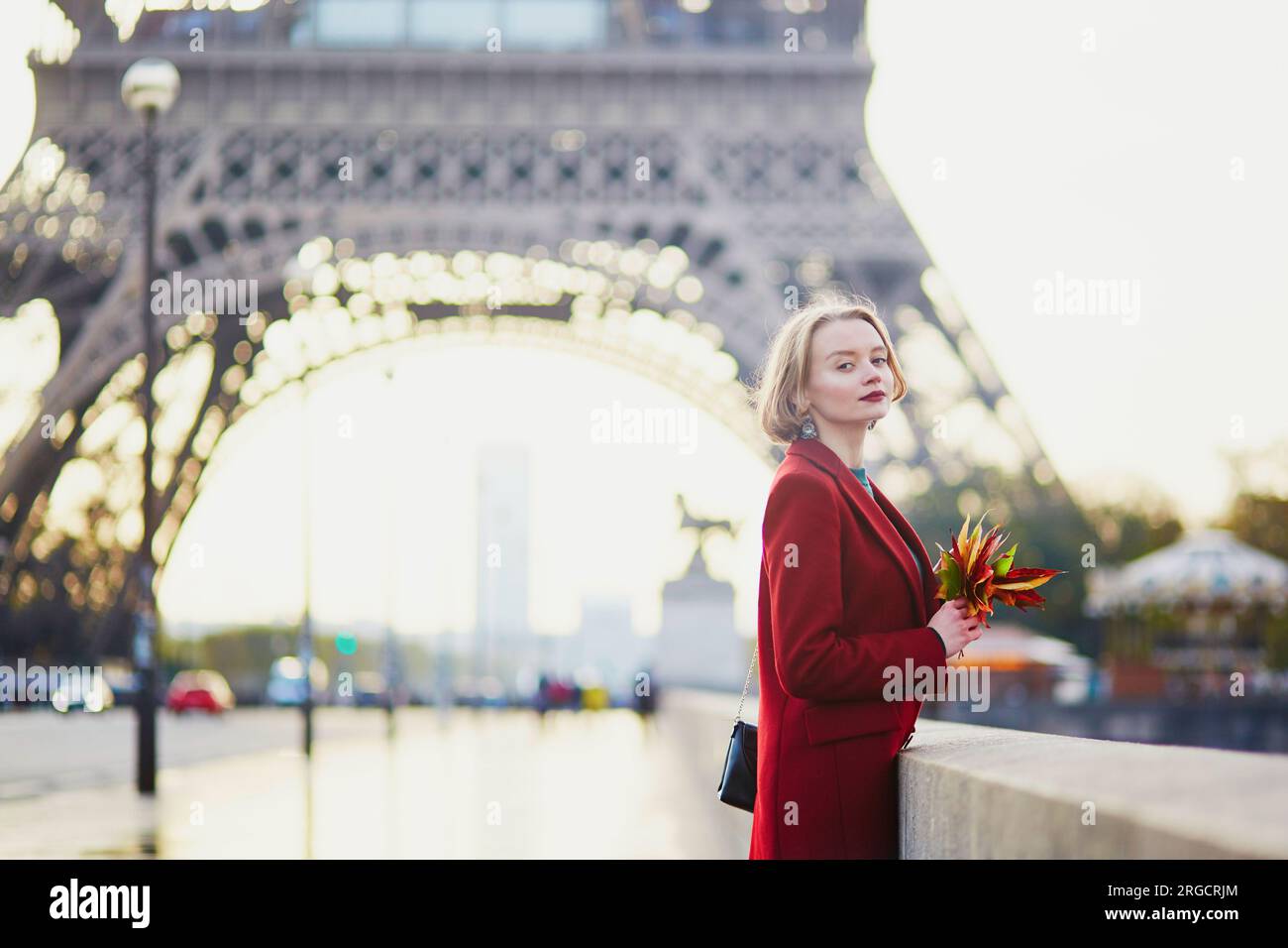 Beautiful young French woman drinking coffee near the Eiffel tower in ...