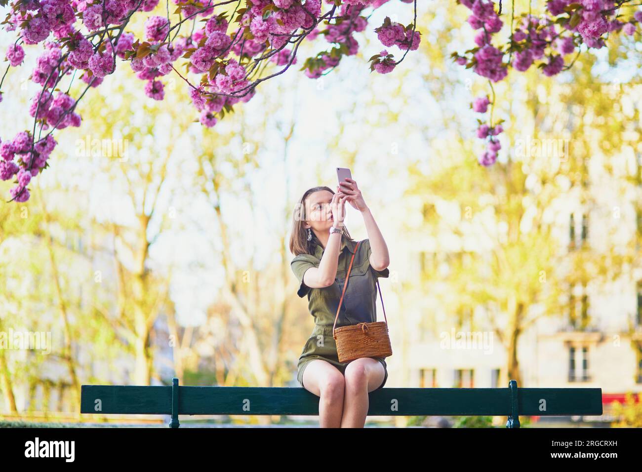 Beautiful French woman walking in Paris on a spring day at cherry ...