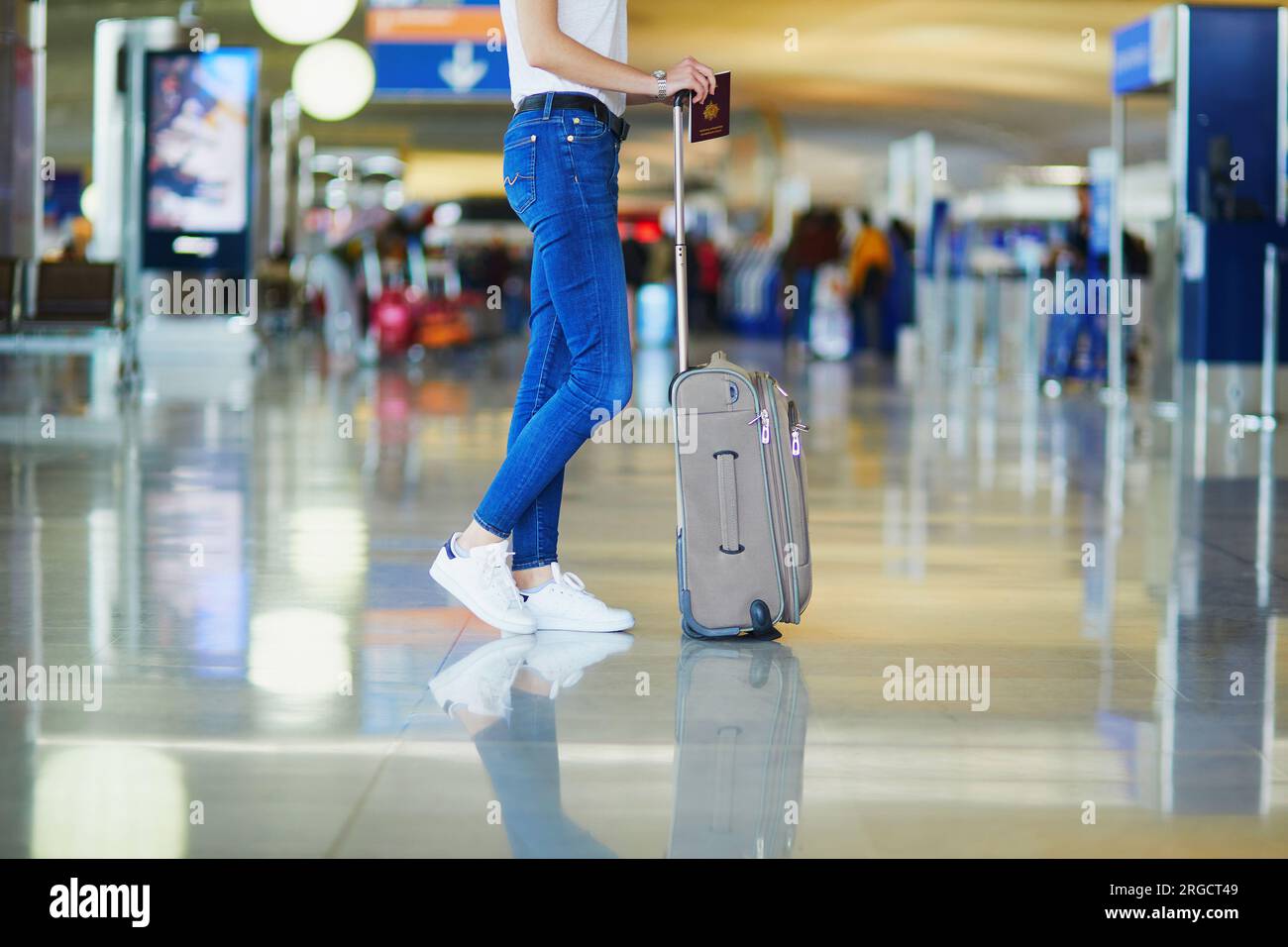 Closeup of woman legs with luggage in international airport. Tourism ...