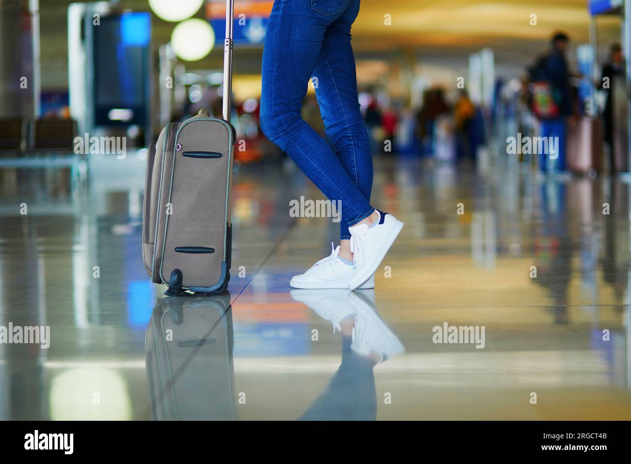 Closeup of woman legs with luggage in international airport. Tourism ...