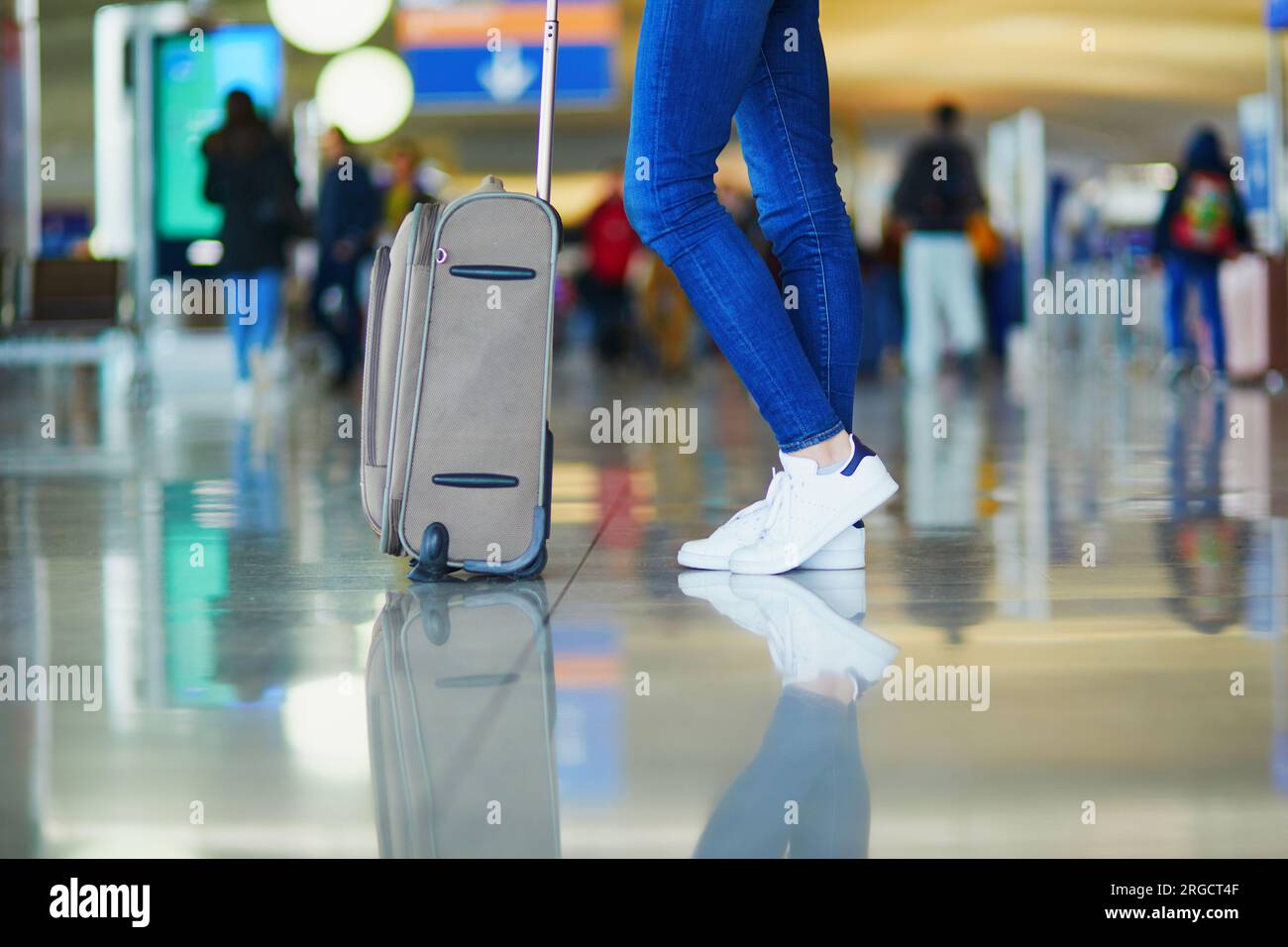 Closeup of woman legs with luggage in international airport. Tourism ...