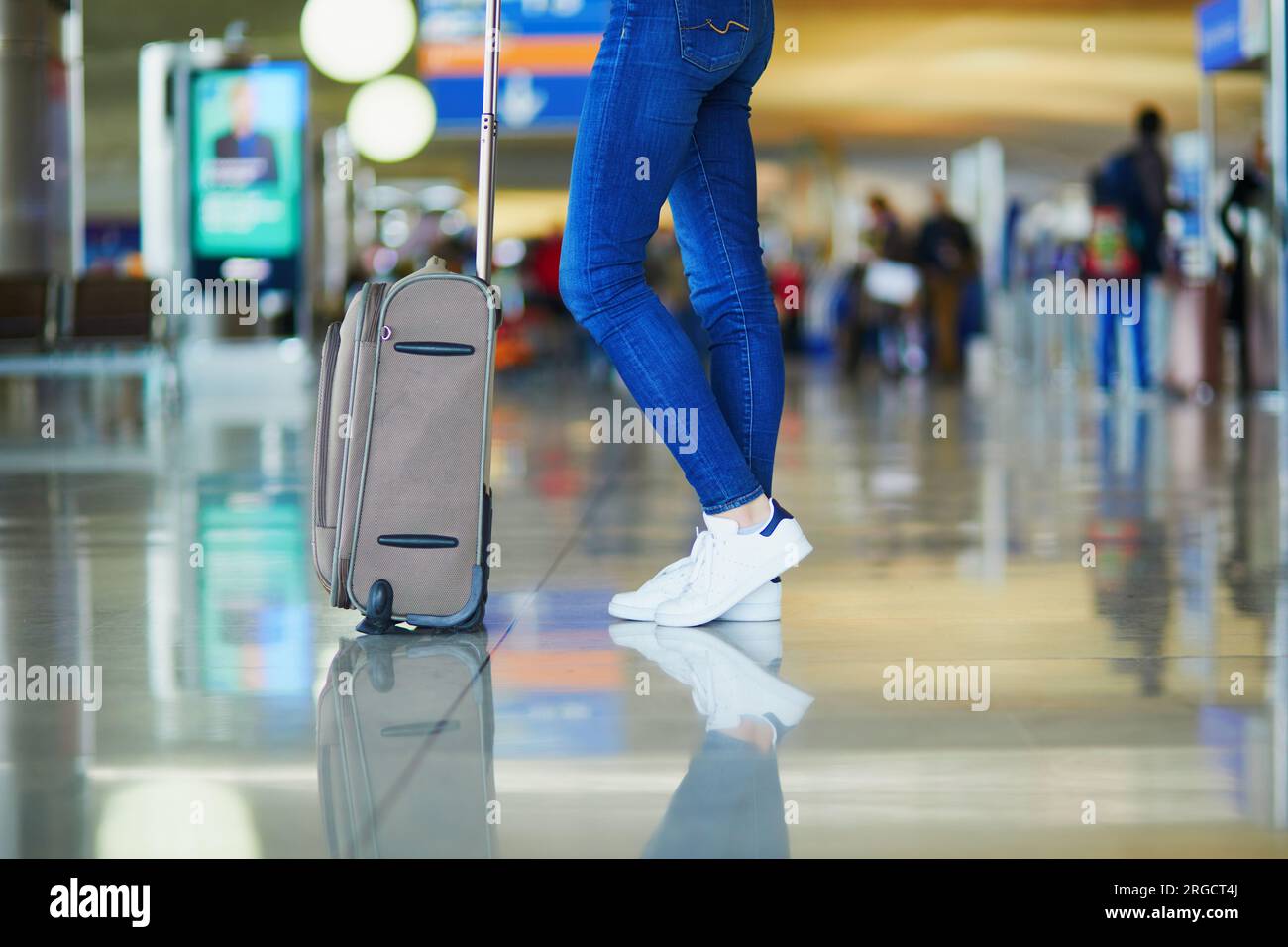 Closeup of woman legs with luggage in international airport. Tourism ...