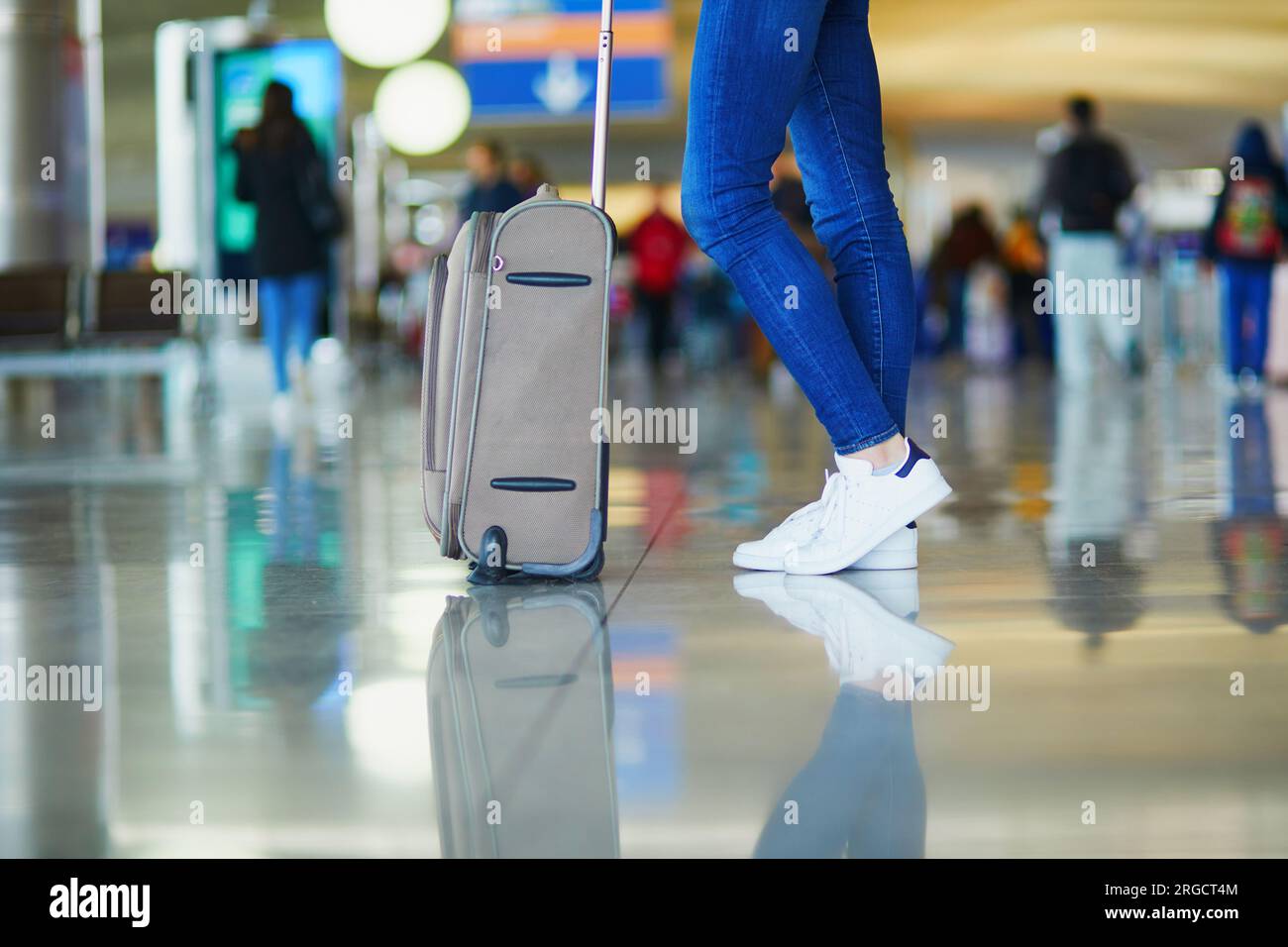 Closeup of woman legs with luggage in international airport. Tourism ...