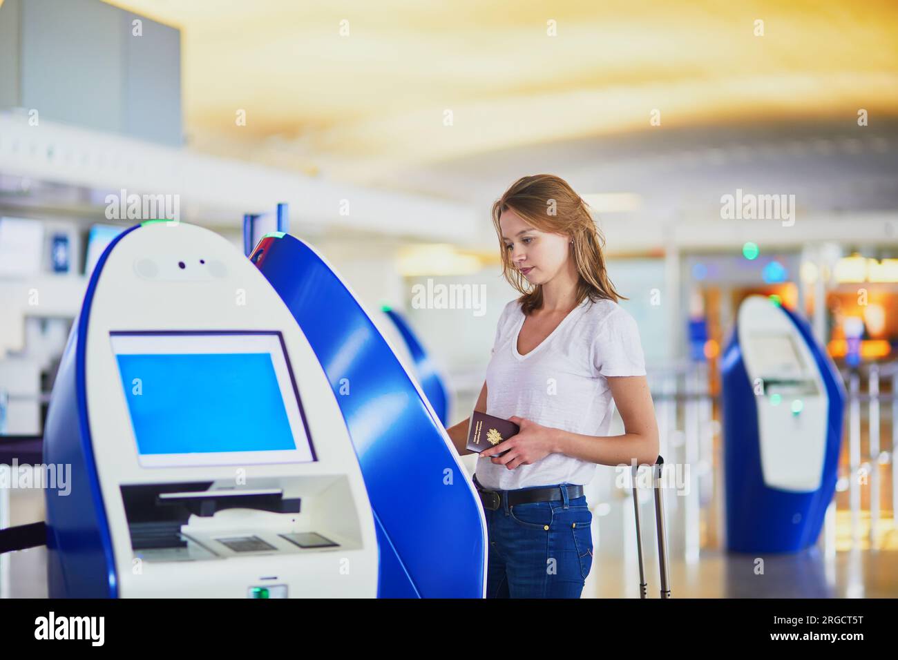 Young woman in international airport doing self check-in Stock Photo ...