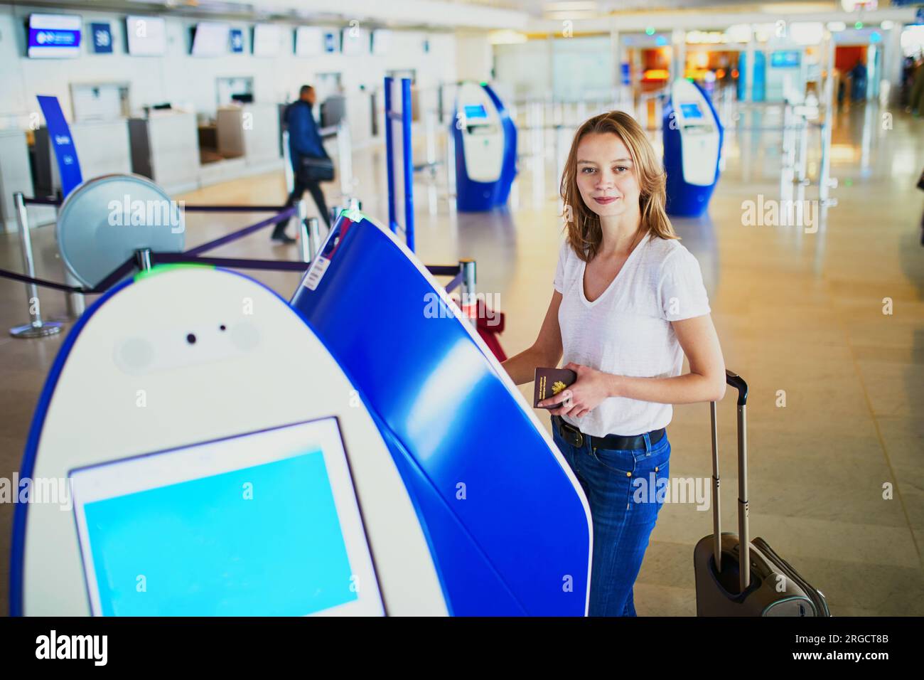 Young woman in international airport doing self check-in Stock Photo ...
