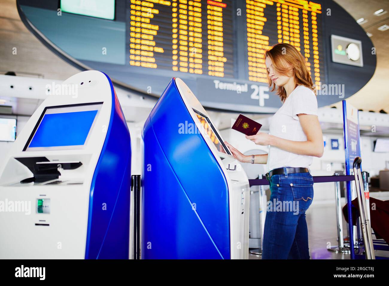 Young woman in international airport doing self check-in Stock Photo ...