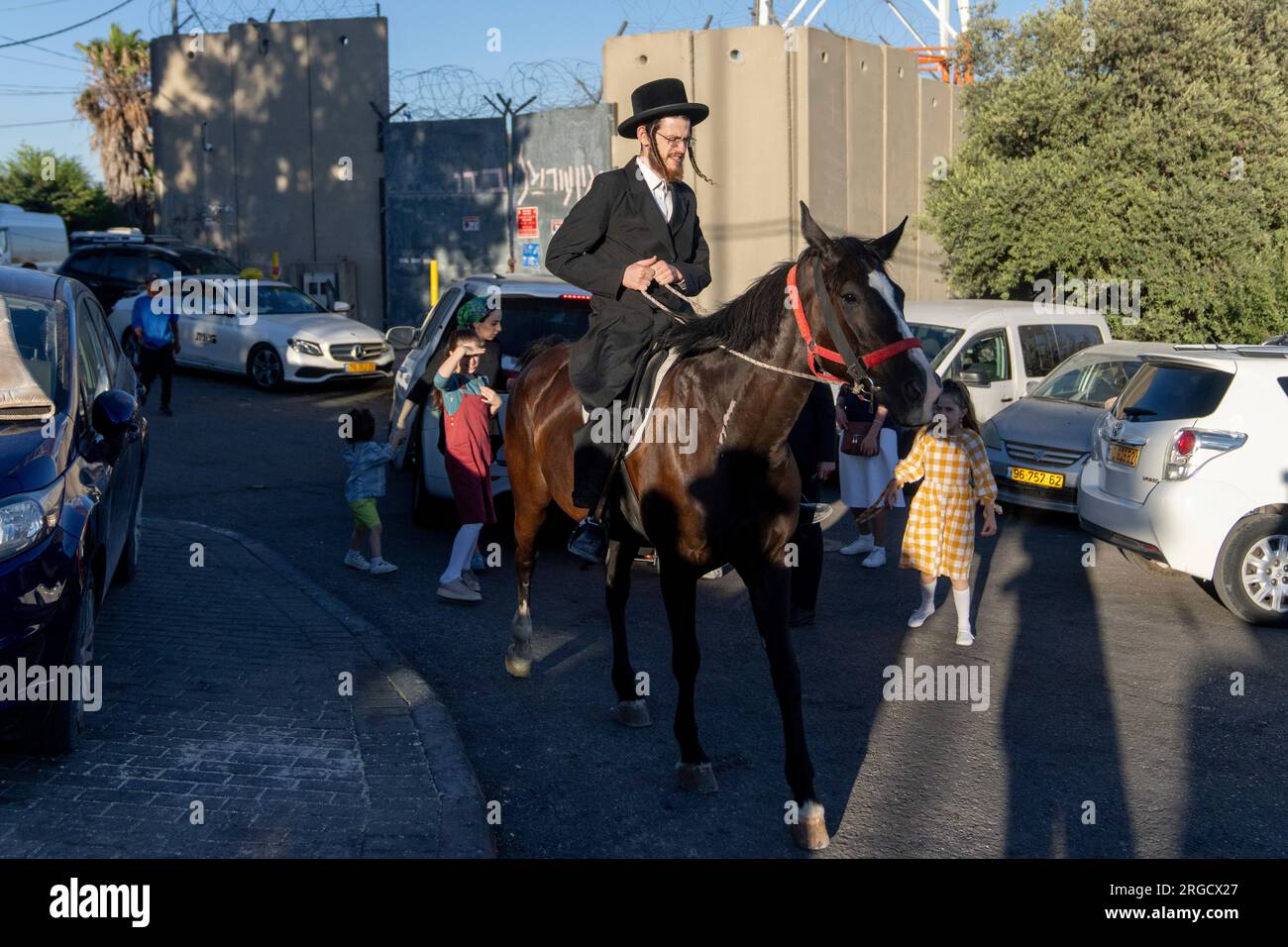 An ultra-Orthodox Jewish man rides a horse at the tomb of Nebi Samuel ...