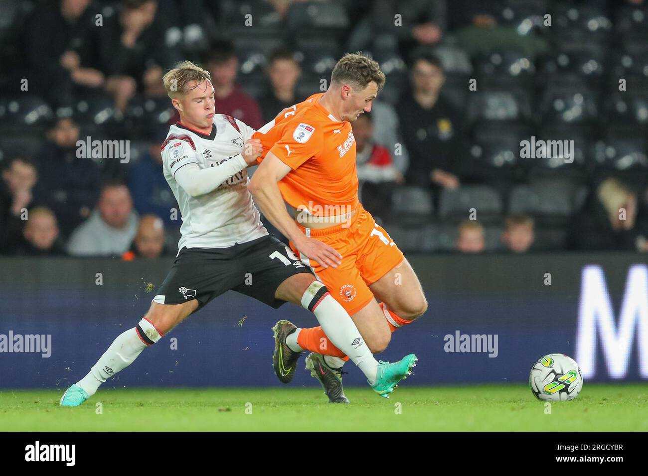 Liam Thompson #16 of Derby County fouls Matty Virtue #17 of Blackpool ...