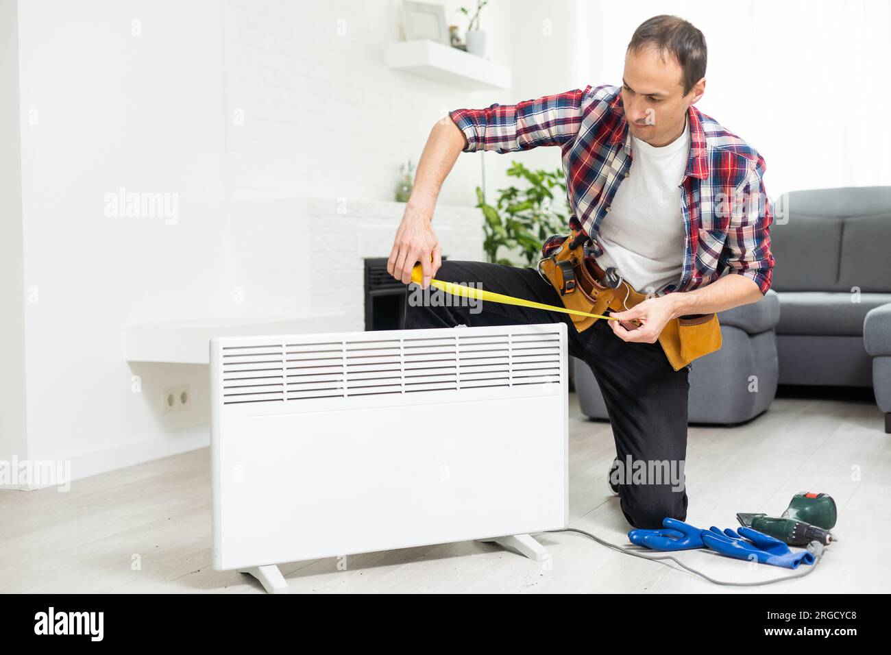Quality help. Handyman using pipe wrench while repairing radiator ...