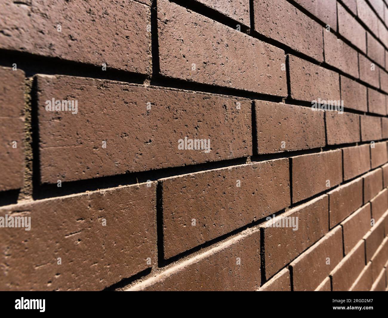 Closeup view of a fashionable deep rich brown brick wall. Point of view ...
