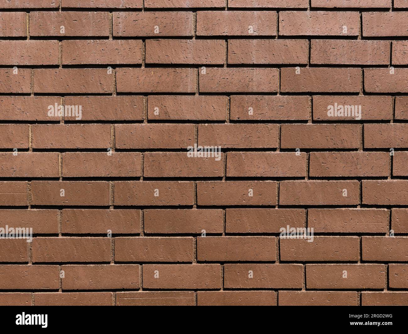Closeup view of a fashionable deep rich brown brick wall Stock Photo ...