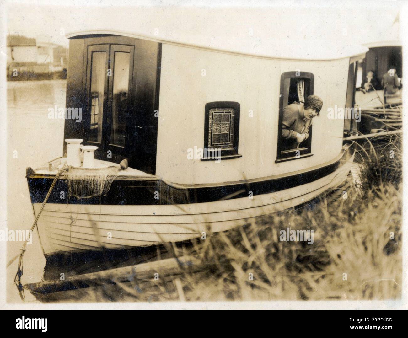 Cute, miniature Houseboat and occupant Stock Photo - Alamy