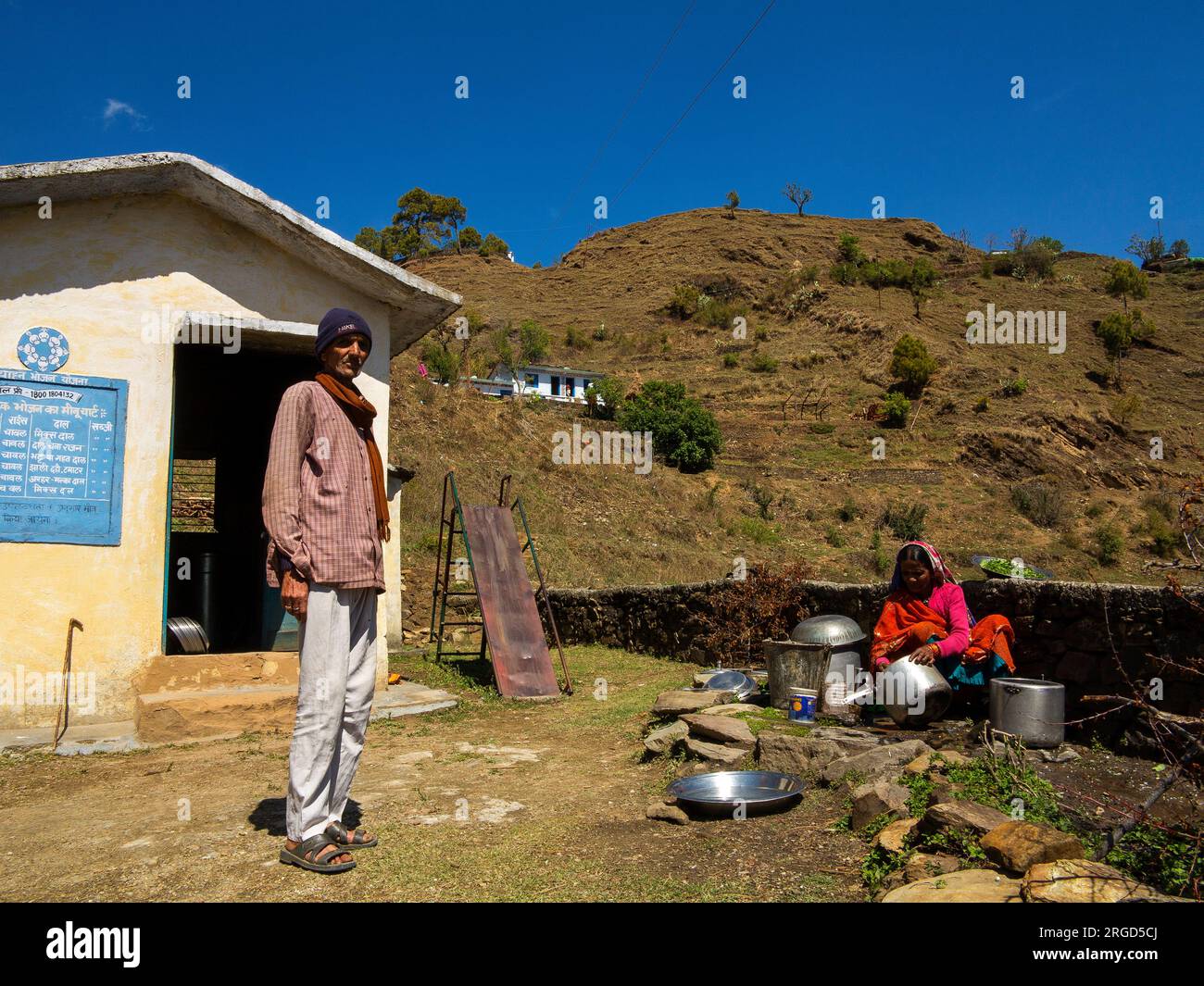 Indian woman washing pans near his house at the outskirts of Lamgara ...