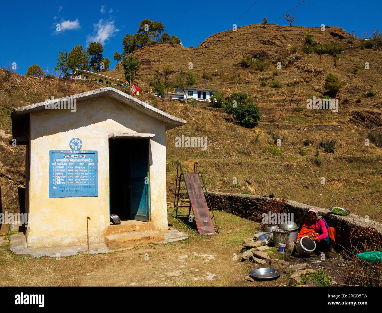 Indian woman washing pans near his house at the outskirts of Lamgara ...