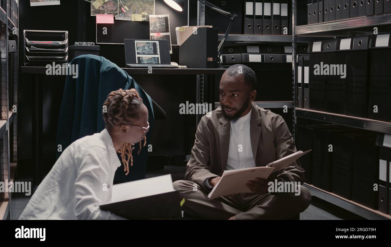 Team of police officers working with forensic evidence to uncover new ...