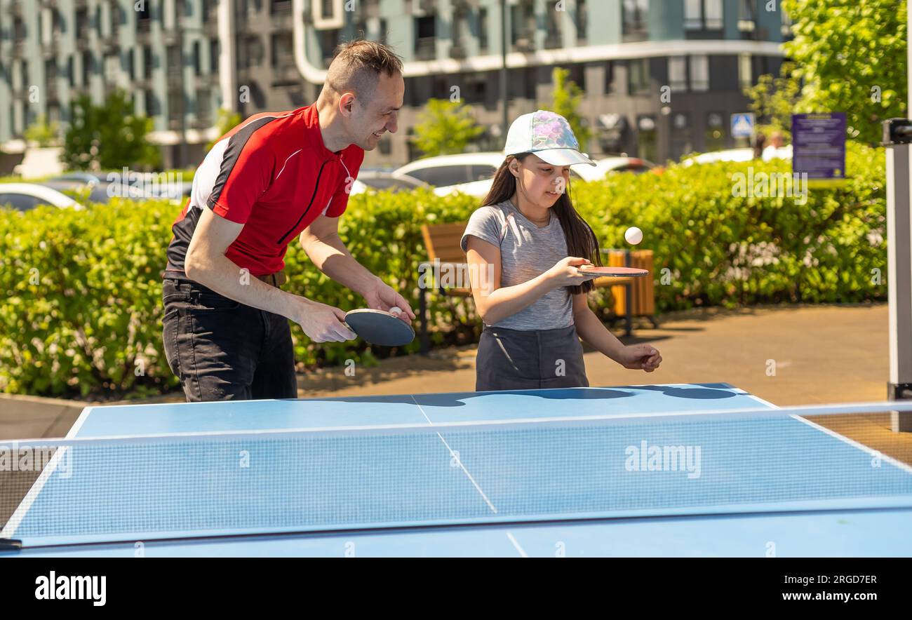 Family playing table tennis outside house Stock Photo - Alamy