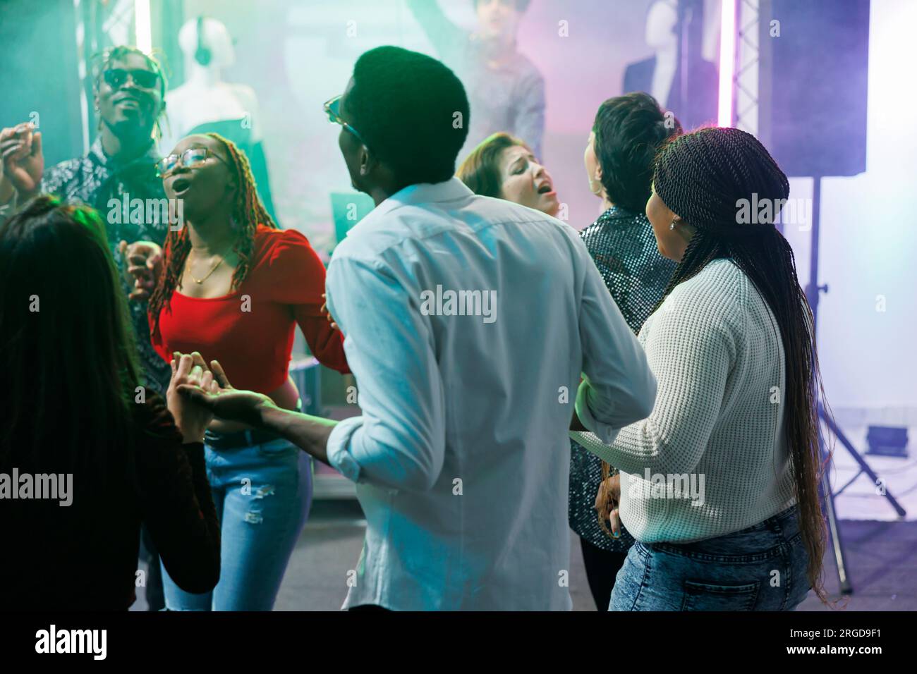 Diverse people clubbing and dancing together at discotheque party event ...