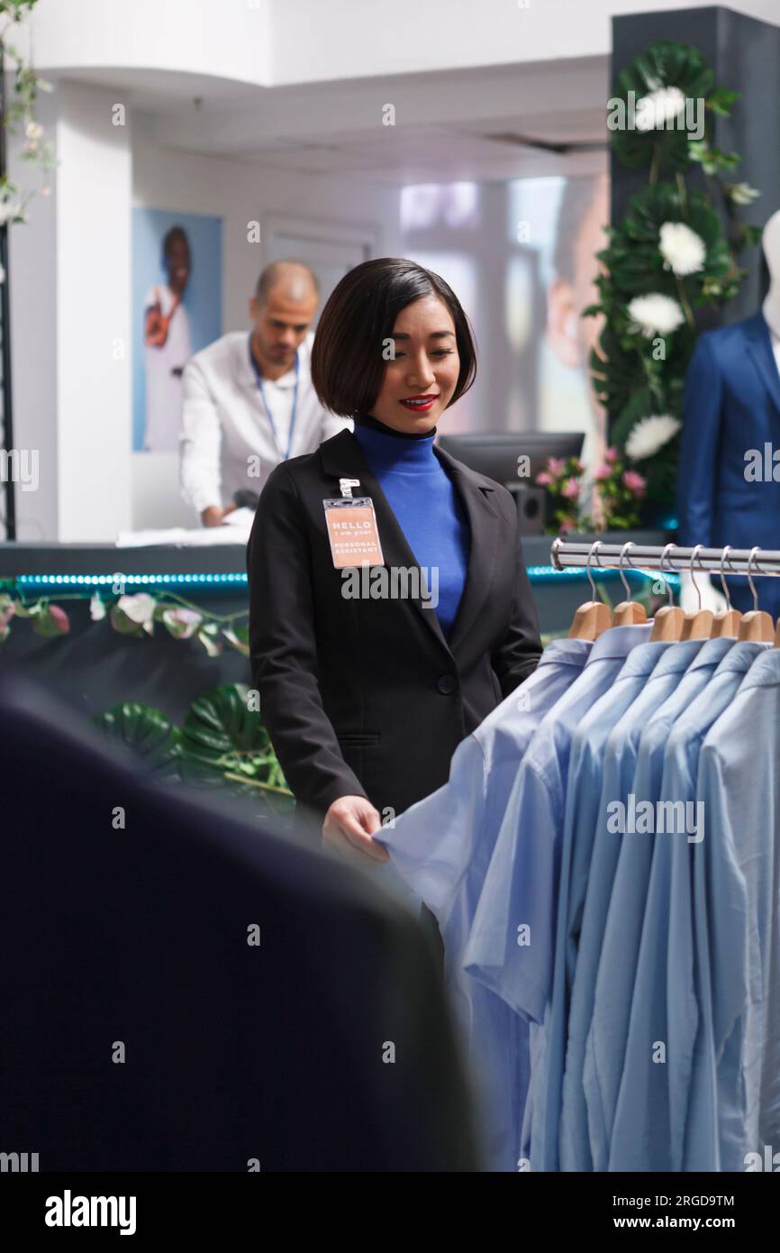 Clothing store employee examining hi-res stock photography and images ...