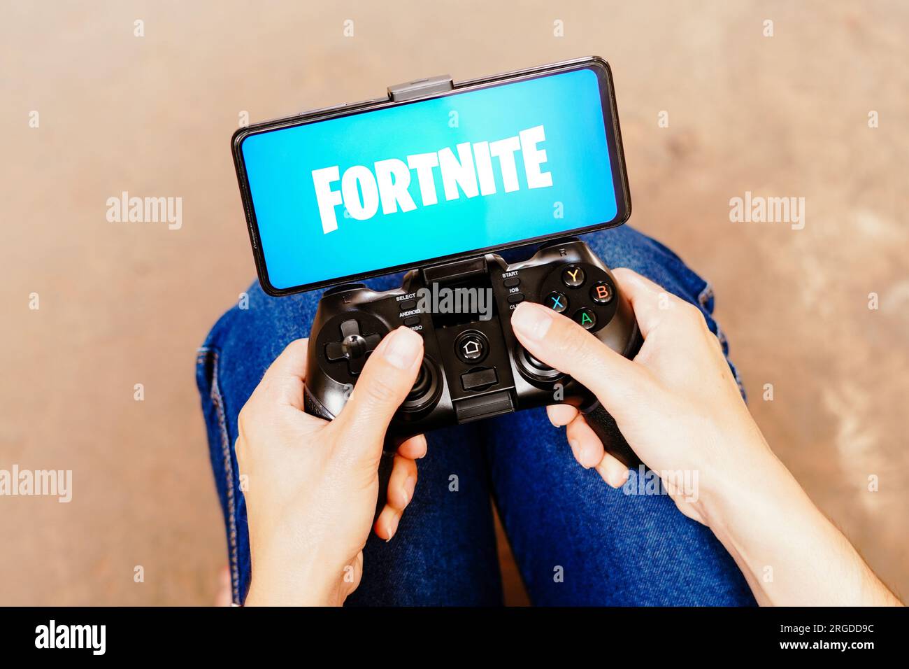 In this photo illustration, a person playing on a joystick and the ...