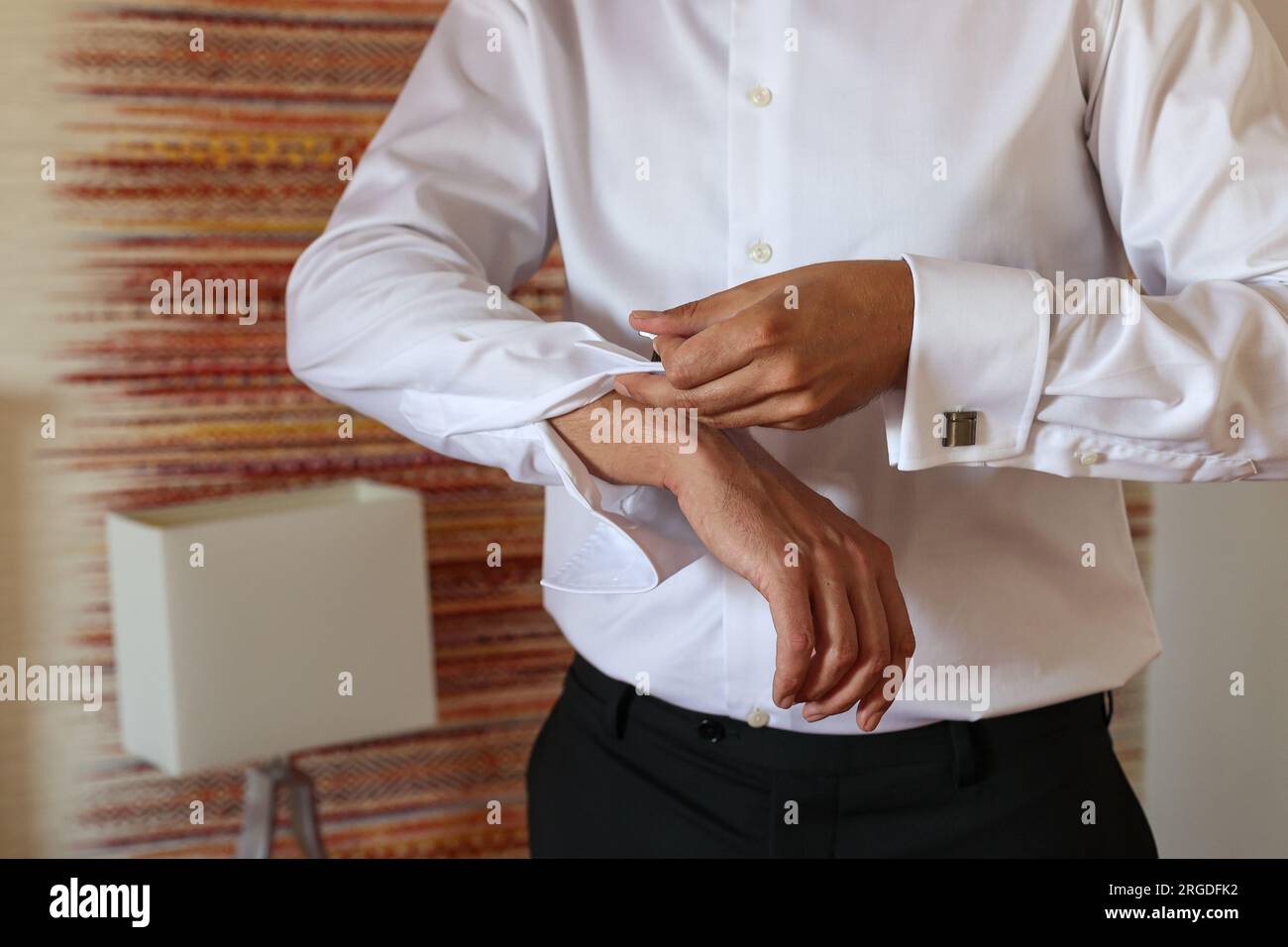 Man putting on his cufflinks. Groom. Business man Stock Photo - Alamy