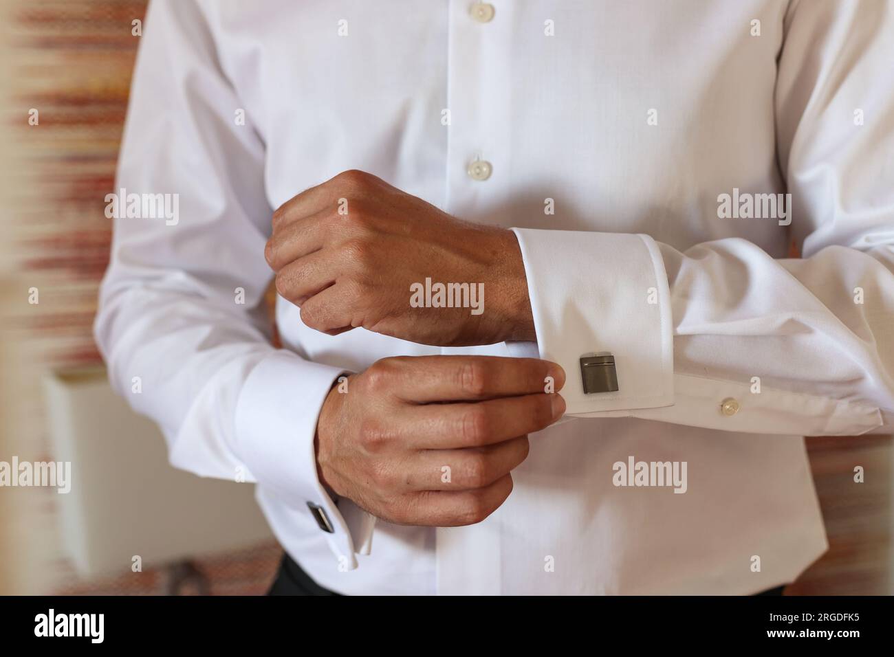Man putting on his cufflinks. Groom. Business man Stock Photo - Alamy