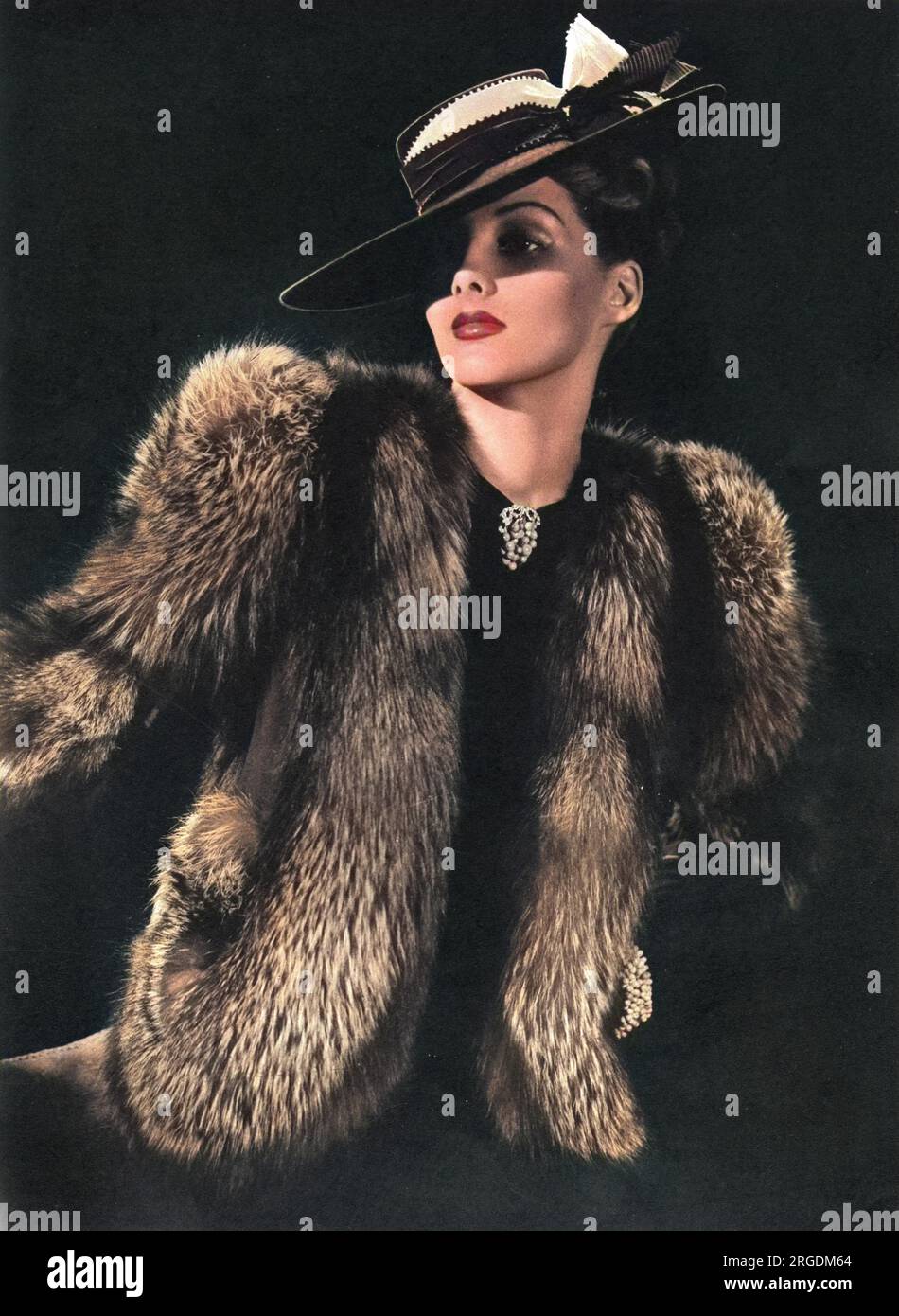 A fur coat worn with an angular hat, available from Harrods department ...