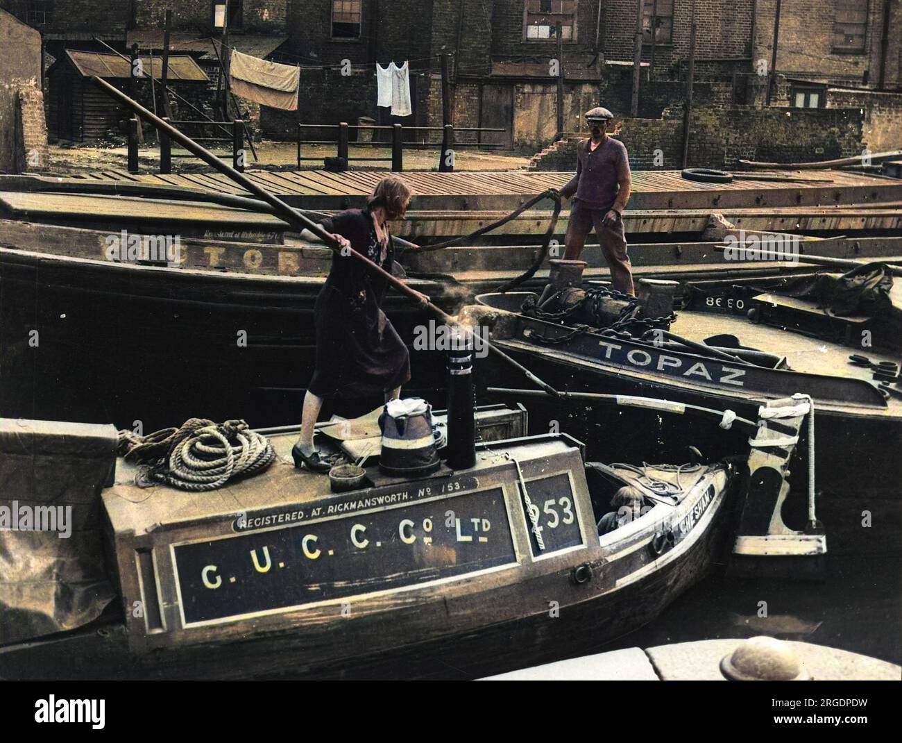Manoeuvering narrow boats in the dock with barge poles on the Grand ...