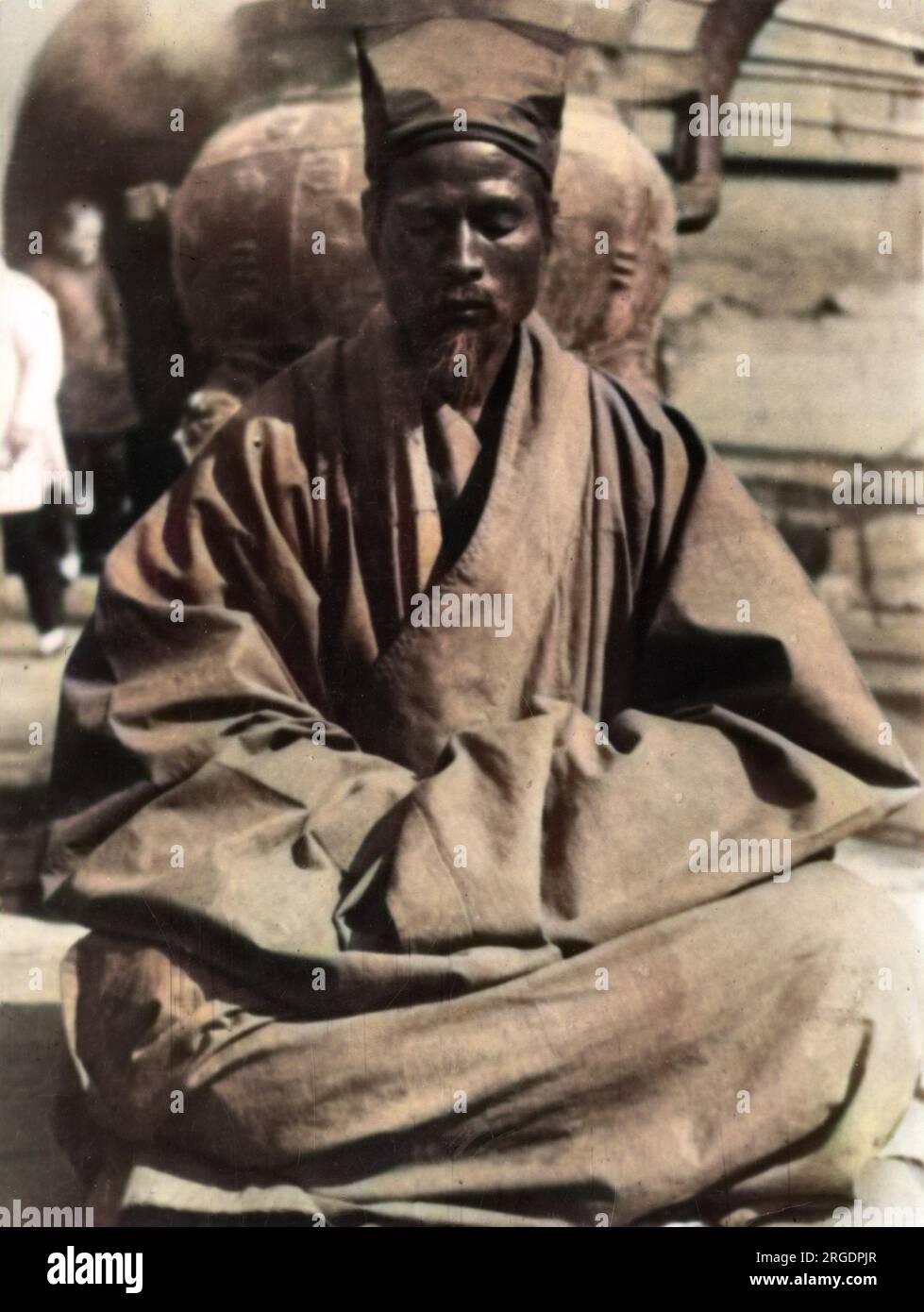 A beggar monk, sitting in the lotus position during meditation ...