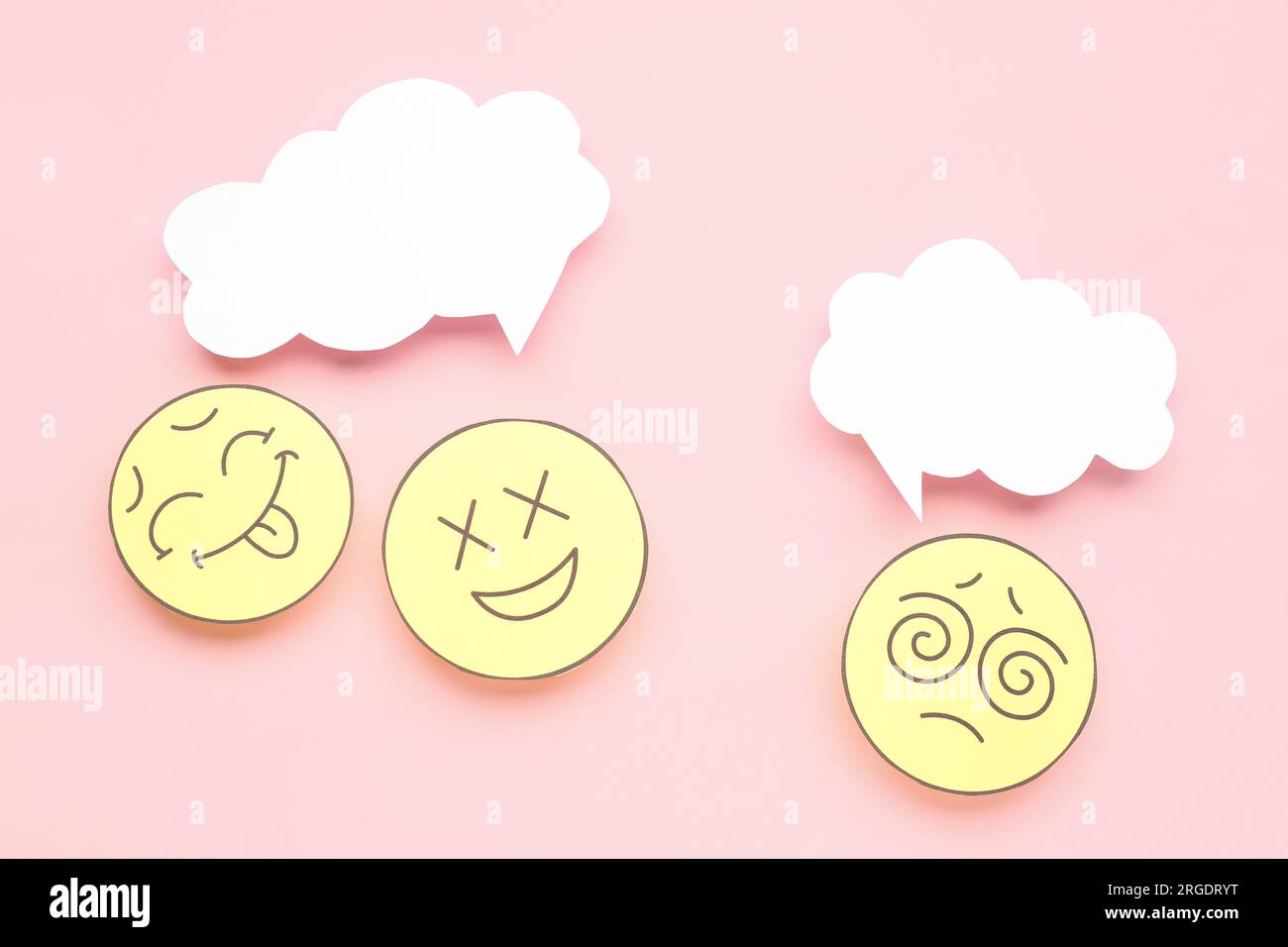 Paper faces with blank speech bubbles on pink background Stock Photo ...