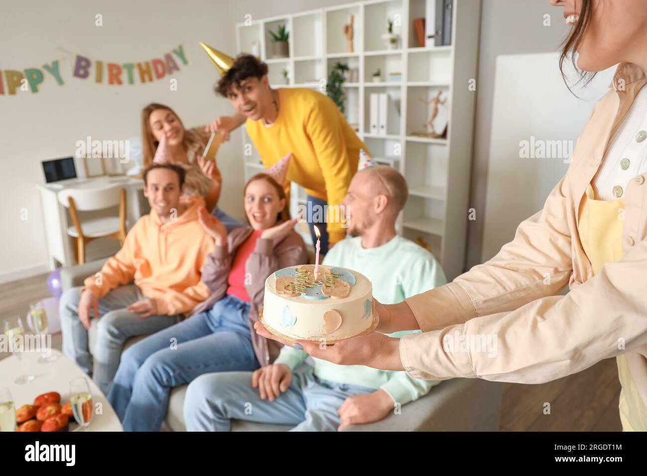 Young woman bringing Birthday cake to her friend at party Stock Photo ...