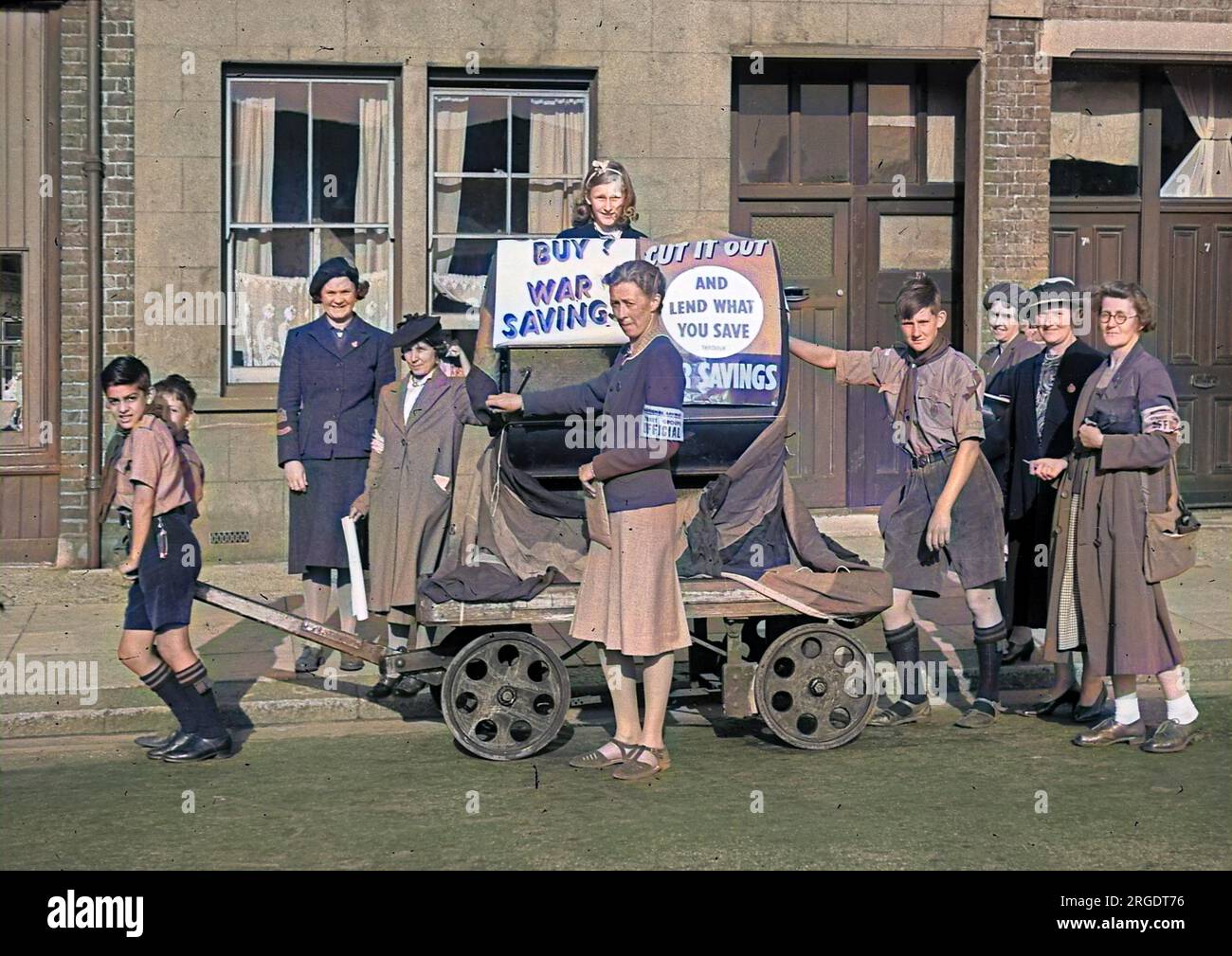 People on a street, encouraging War Savings to help the war effort ...