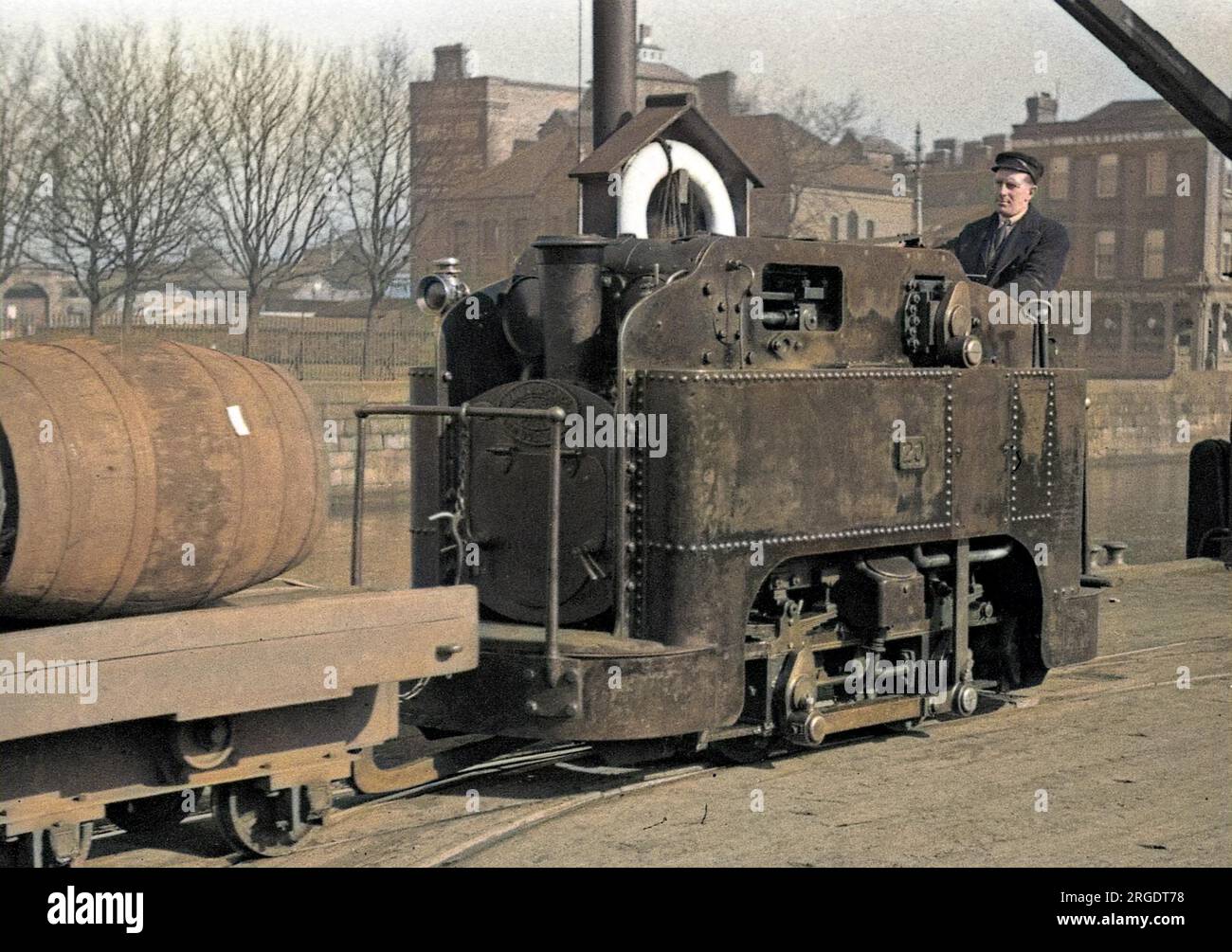 A man driving a tram engine to transport barrels Stock Photo - Alamy