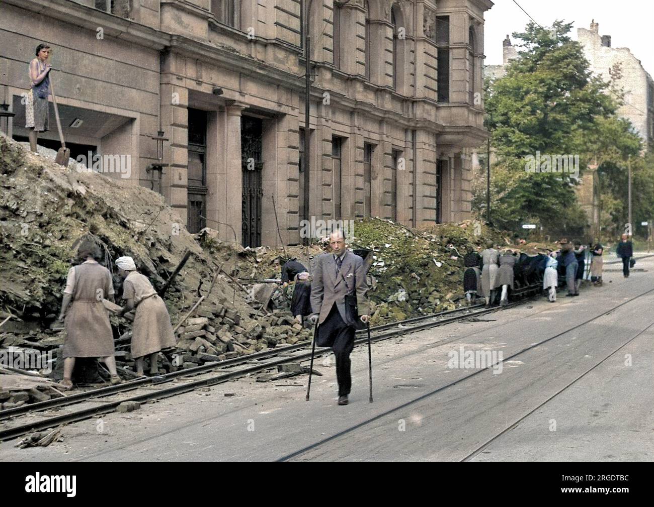 People in a bomb damaged street in Germany during the Second World War ...