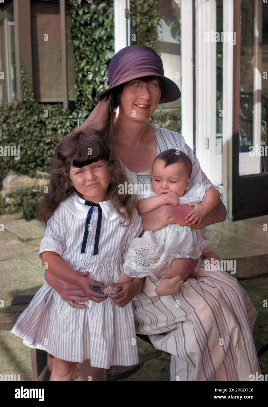 A woman with two children, a little girl and a baby Stock Photo - Alamy