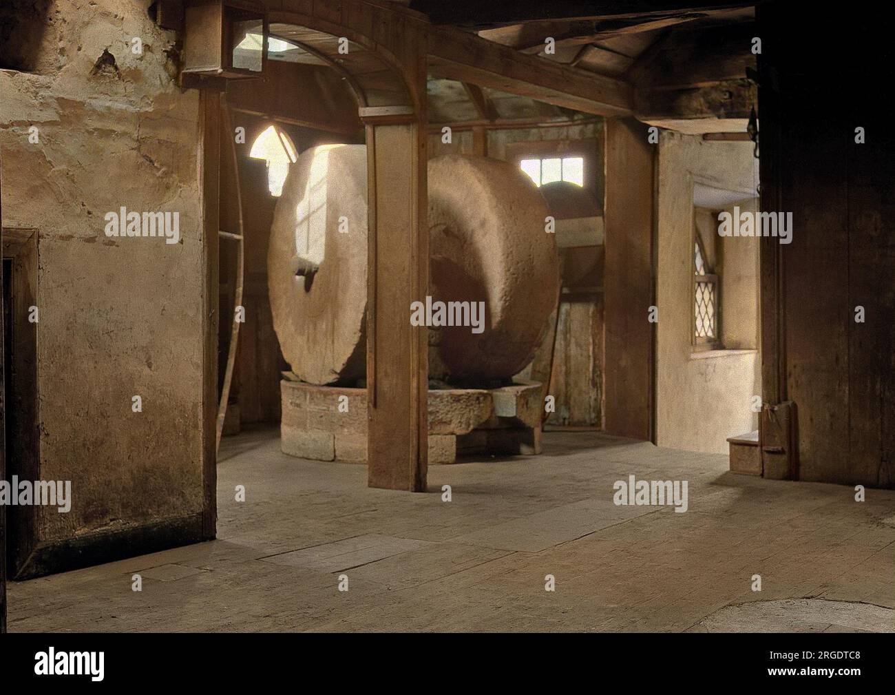 Interior view of a mill with two round millstones at the centre Stock ...