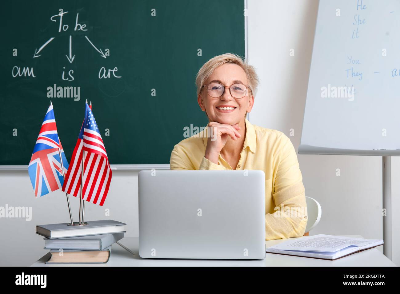 Female English teacher giving online grammar lesson in classroom Stock ...