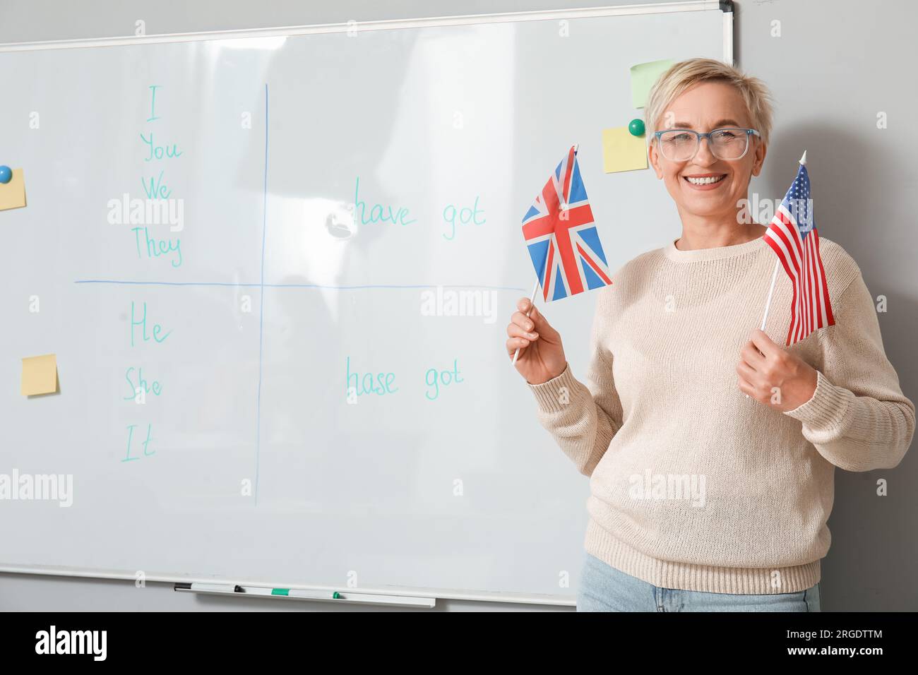 Female English teacher with UK and USA flags in classroom Stock Photo ...