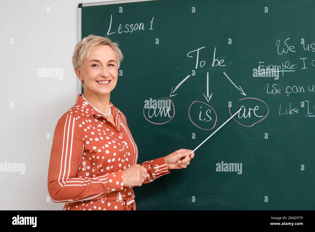 Female English teacher conducting grammar lesson in classroom Stock ...