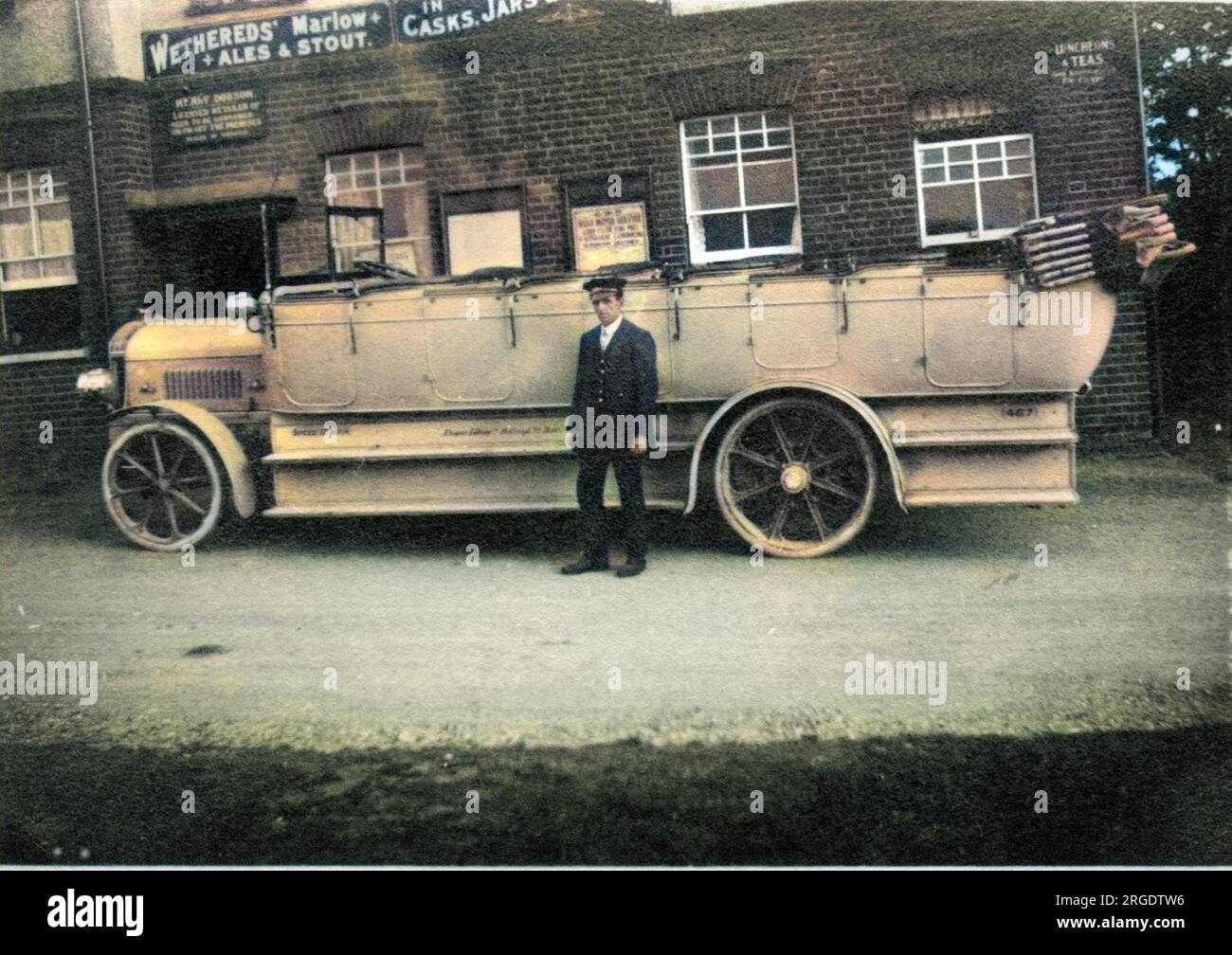 Driver standing in front of his charabanc outside a pub Stock Photo - Alamy