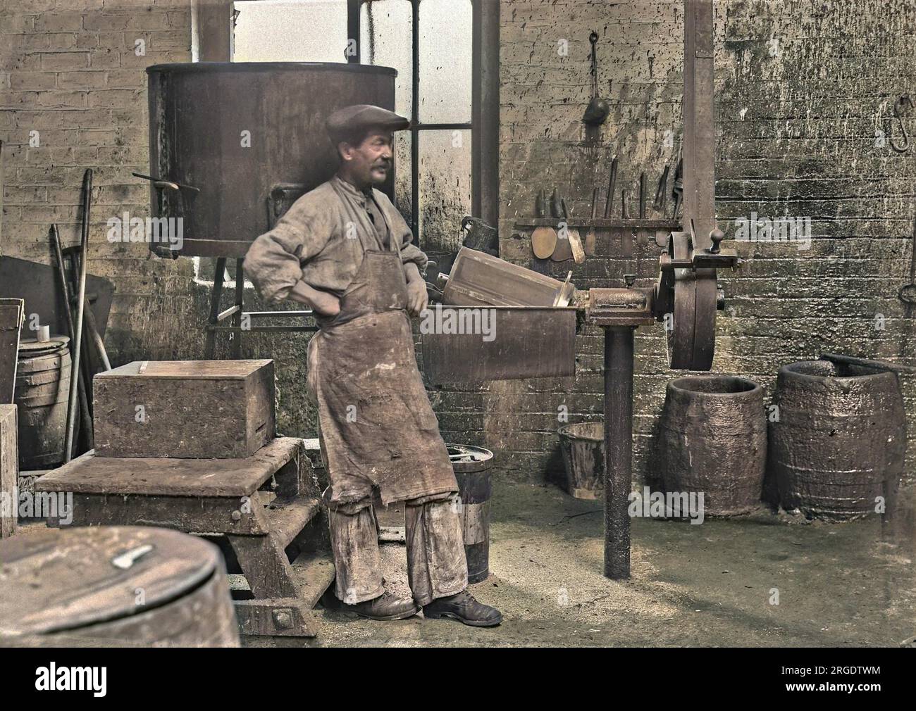 A workman in a factory, having a break from his work. The factory ...