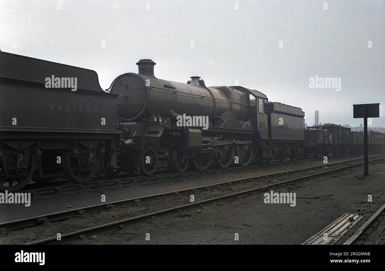 A Great Western steam engine on a railway track, with tender and trucks ...