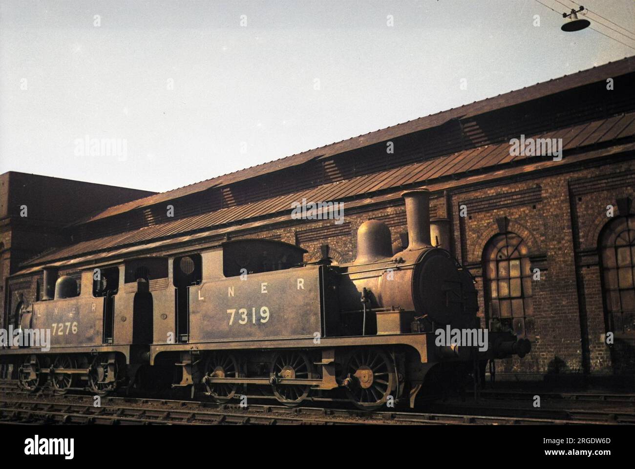 Two LNER (London & North Eastern) steam engines on a railway track ...